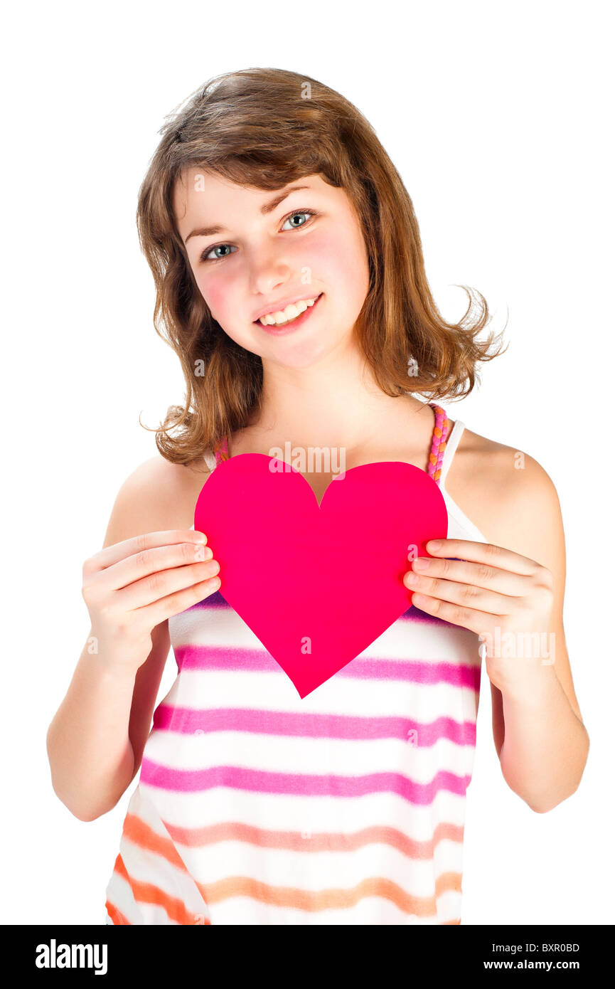 Cute smiling girl in bright dress holding valentine heart made of red ...