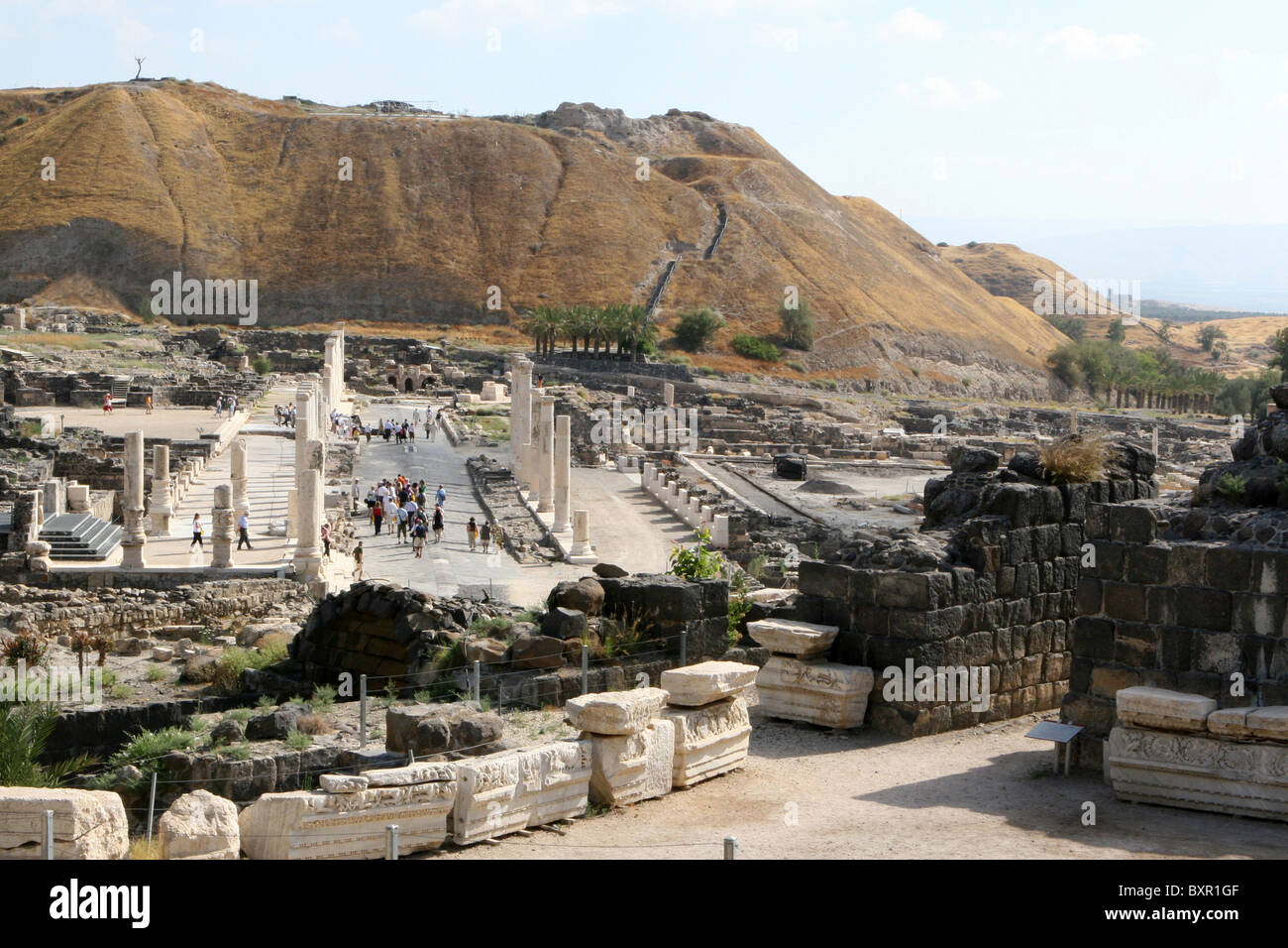 Tourists walk the ancient streets of Bet Shean National Park in Israel ...