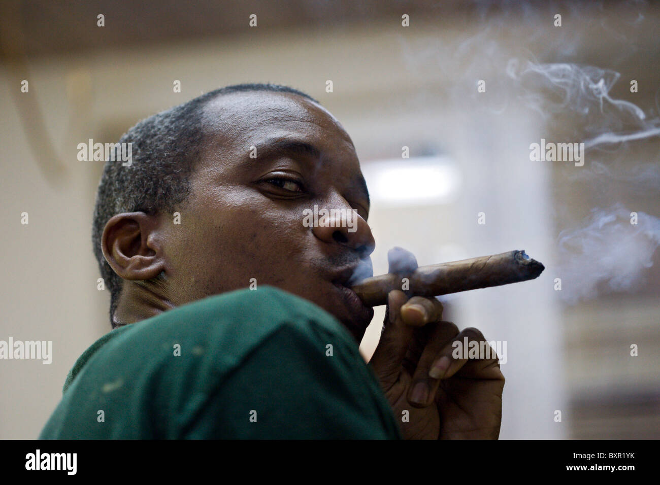 A worker in a cigar factory smoking a cigar Stock Photo - Alamy