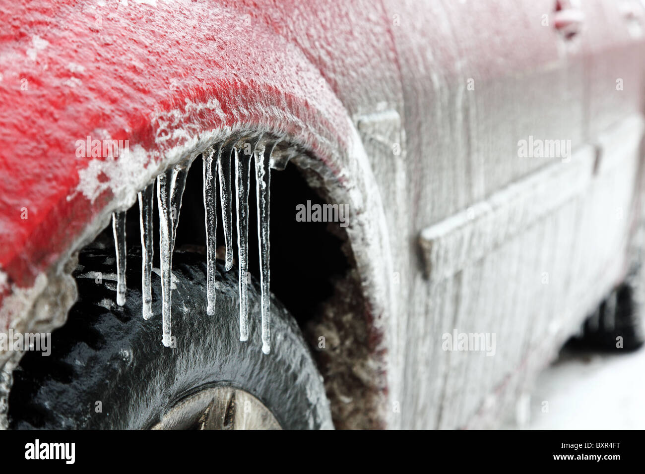 Extreme winter series. Car in ice. Icicles on a wheel arch close-up ...