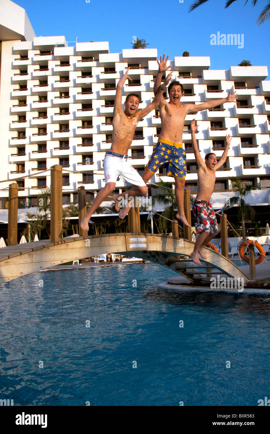 Teenage boys jumping into hotel swimming pool Stock Photo - Alamy