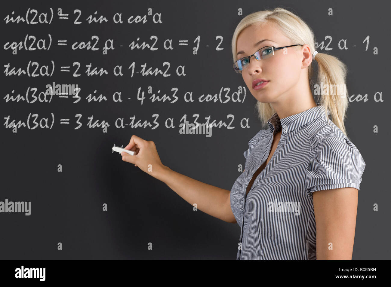 pretty young teacher with blond hair and glasses taking a math lesson ...
