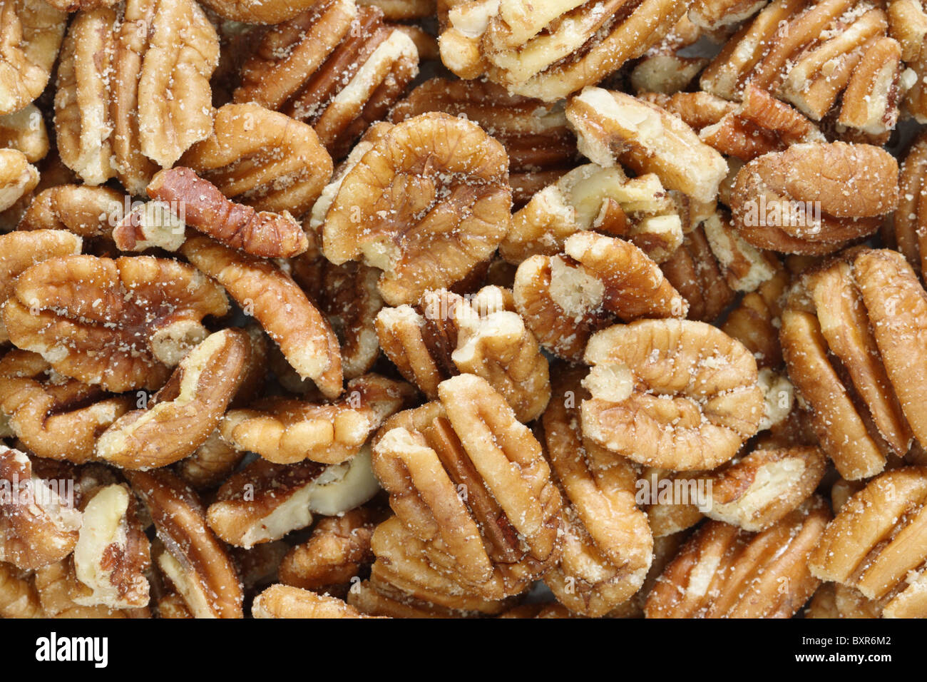 background of roasted salted pecan halves close up Stock Photo - Alamy