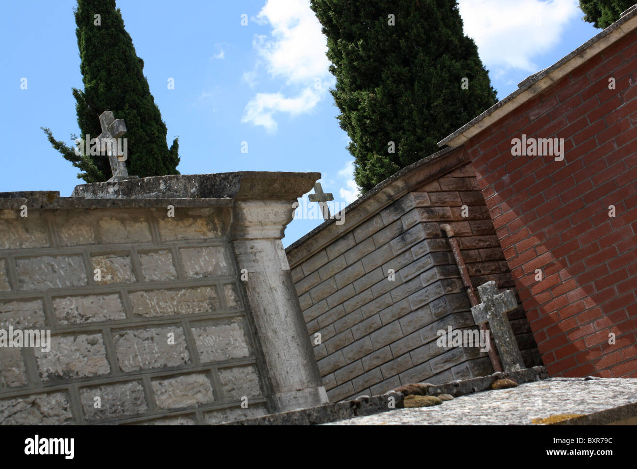 Italian graveyard showing brick graves and crucifix statues Stock Photo ...