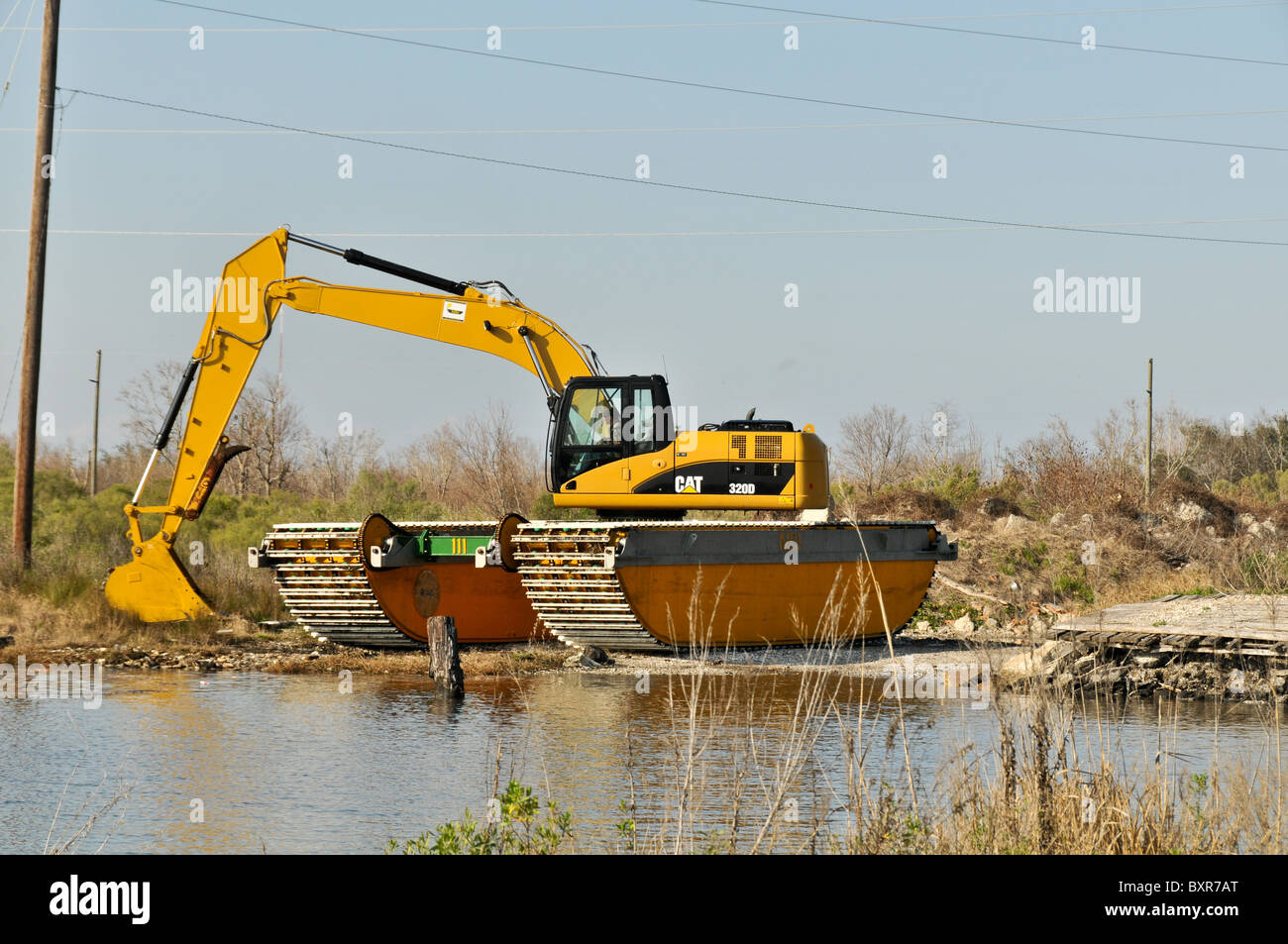 Floating excavator on land in Mississippi River delta, New Orleans ...