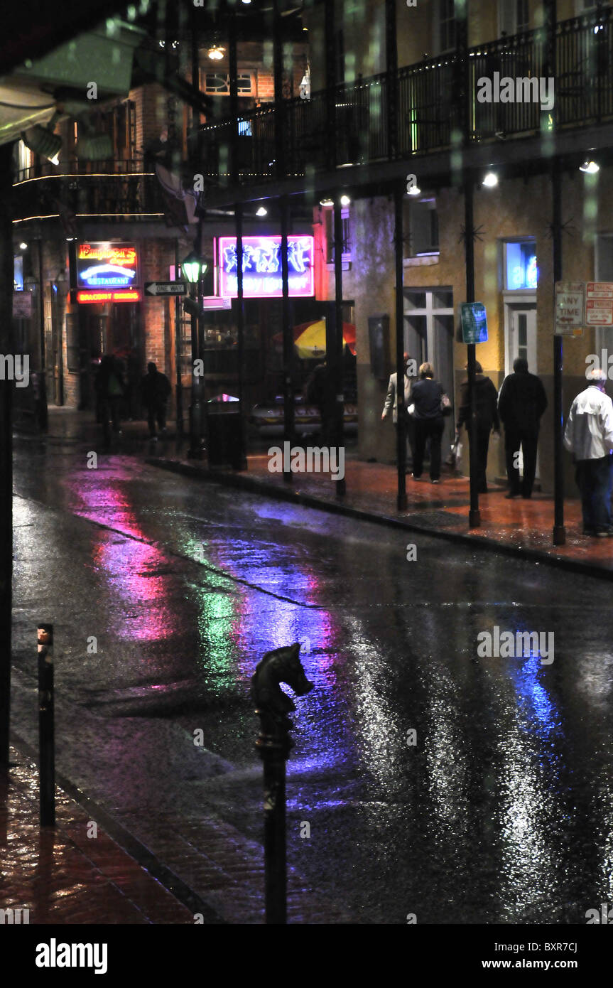 Colorful reflections of neon signs on wet pavement, Bourbon Street ...