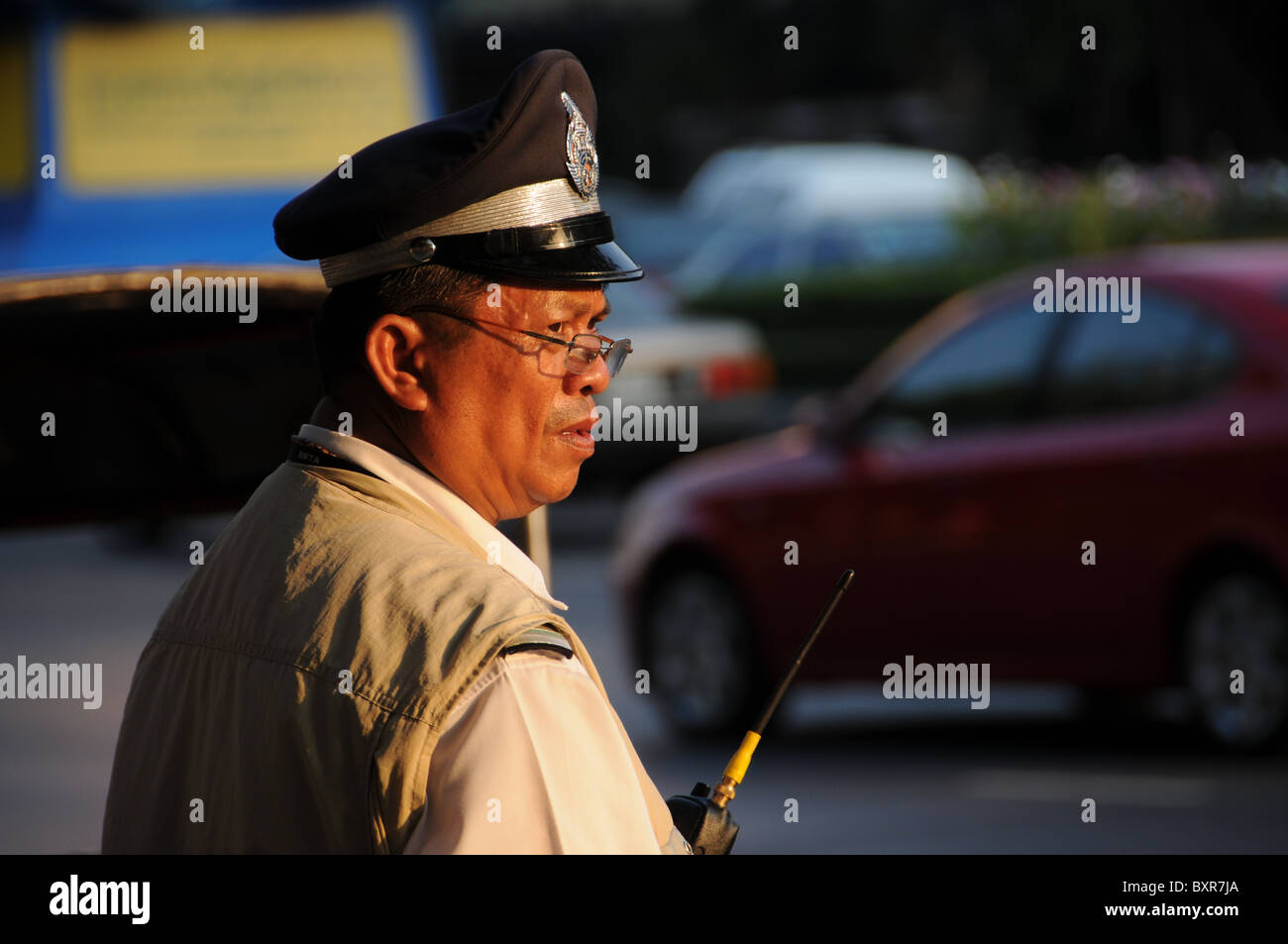 Policeman watching Streettraffic Stock Photo - Alamy