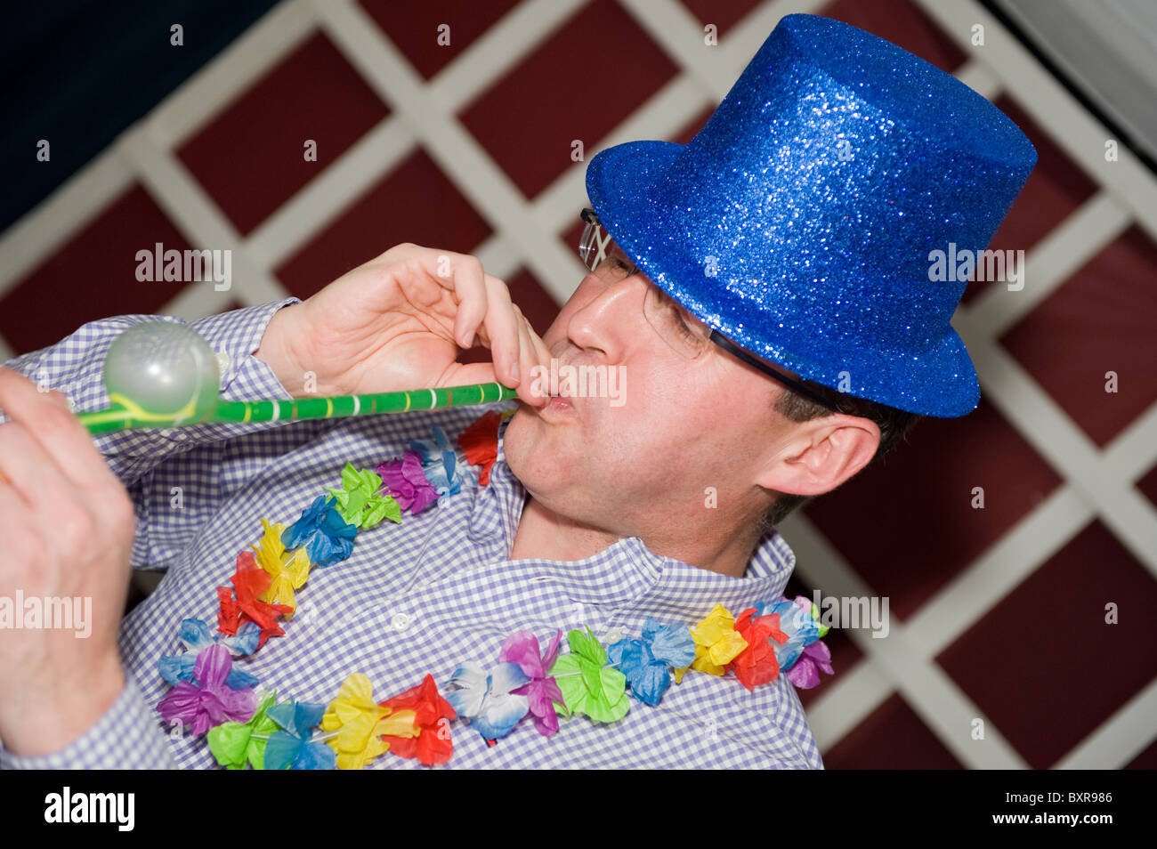 A partygoer blows a balloon at a Christmas party 2010 Stock Photo - Alamy