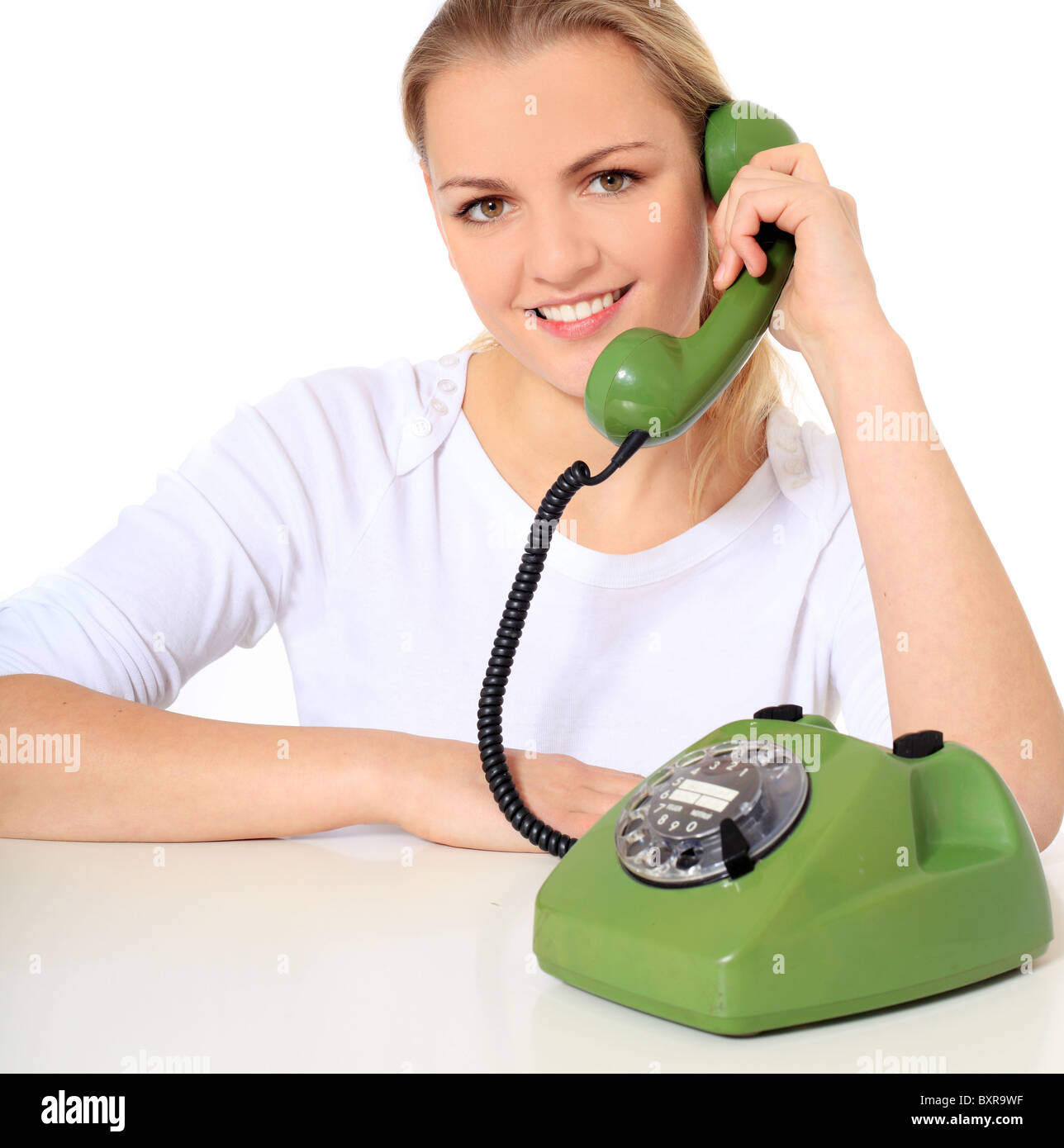 Attractive blonde woman making a phone call. All on white background ...