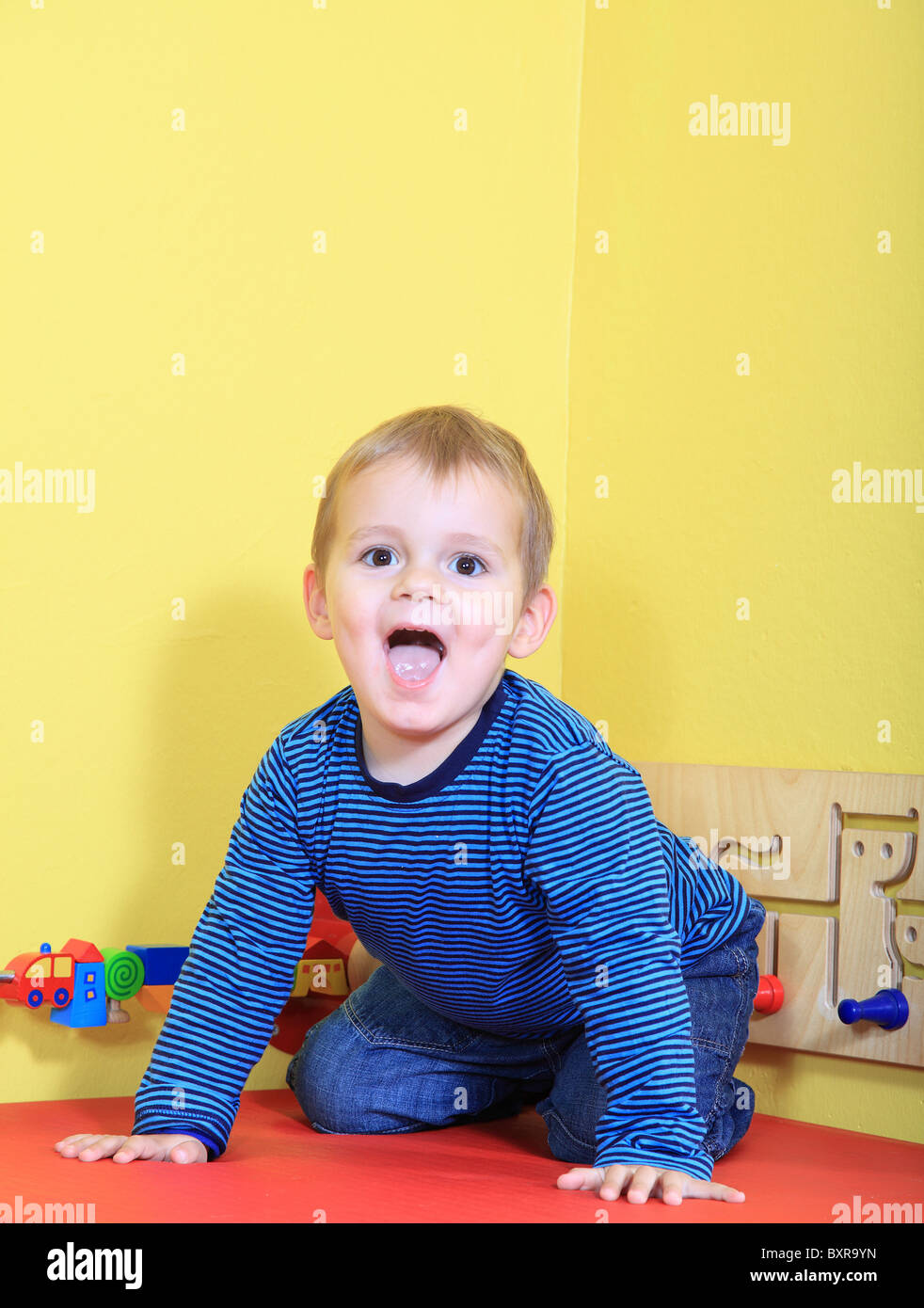 Cute caucasian toddler having fun in kindergarten Stock Photo - Alamy