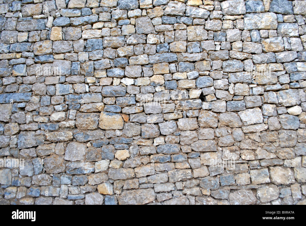 regular wall built with stones and colorful Stock Photo - Alamy