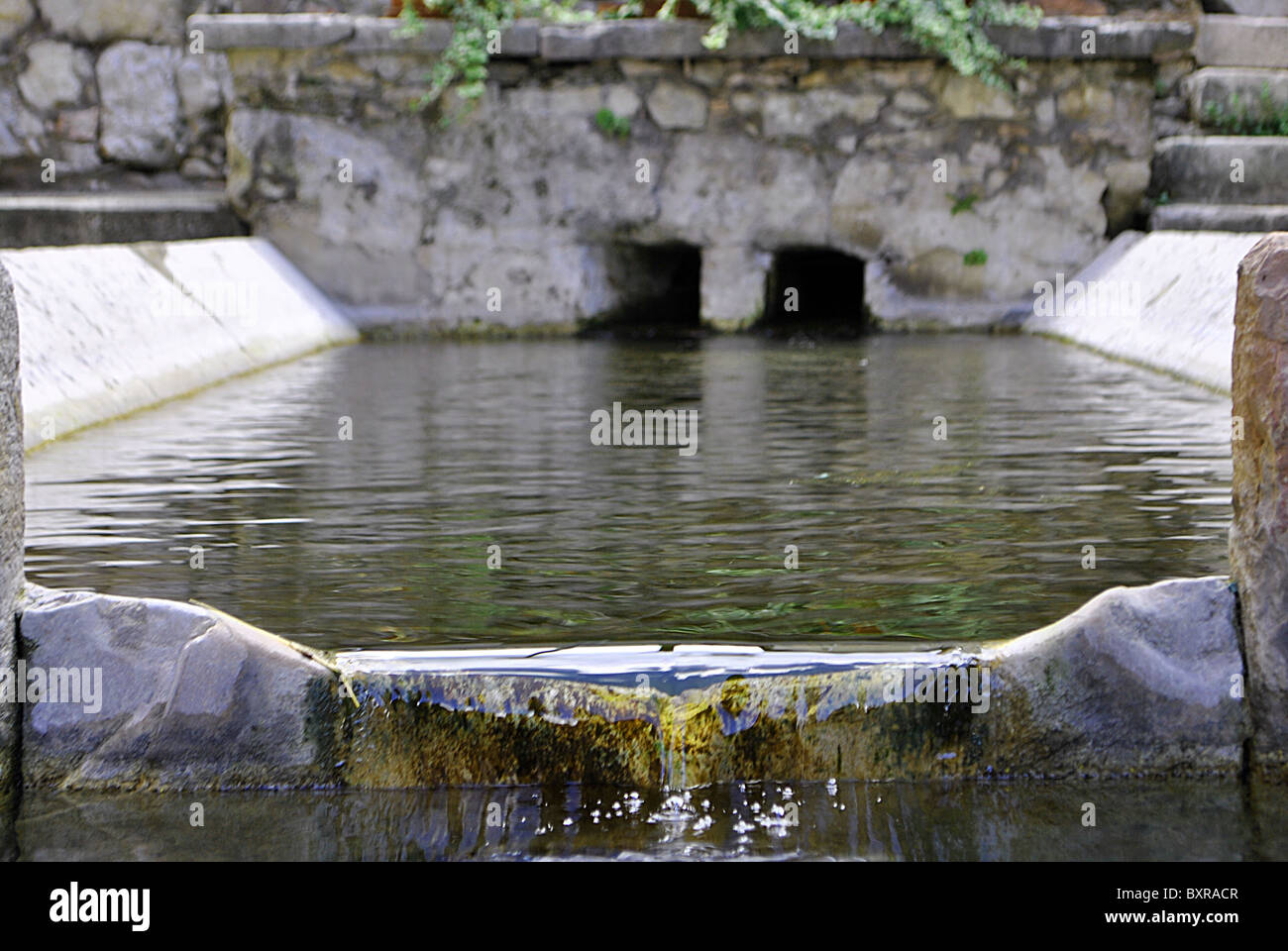 stone fountain with spring water Stock Photo - Alamy
