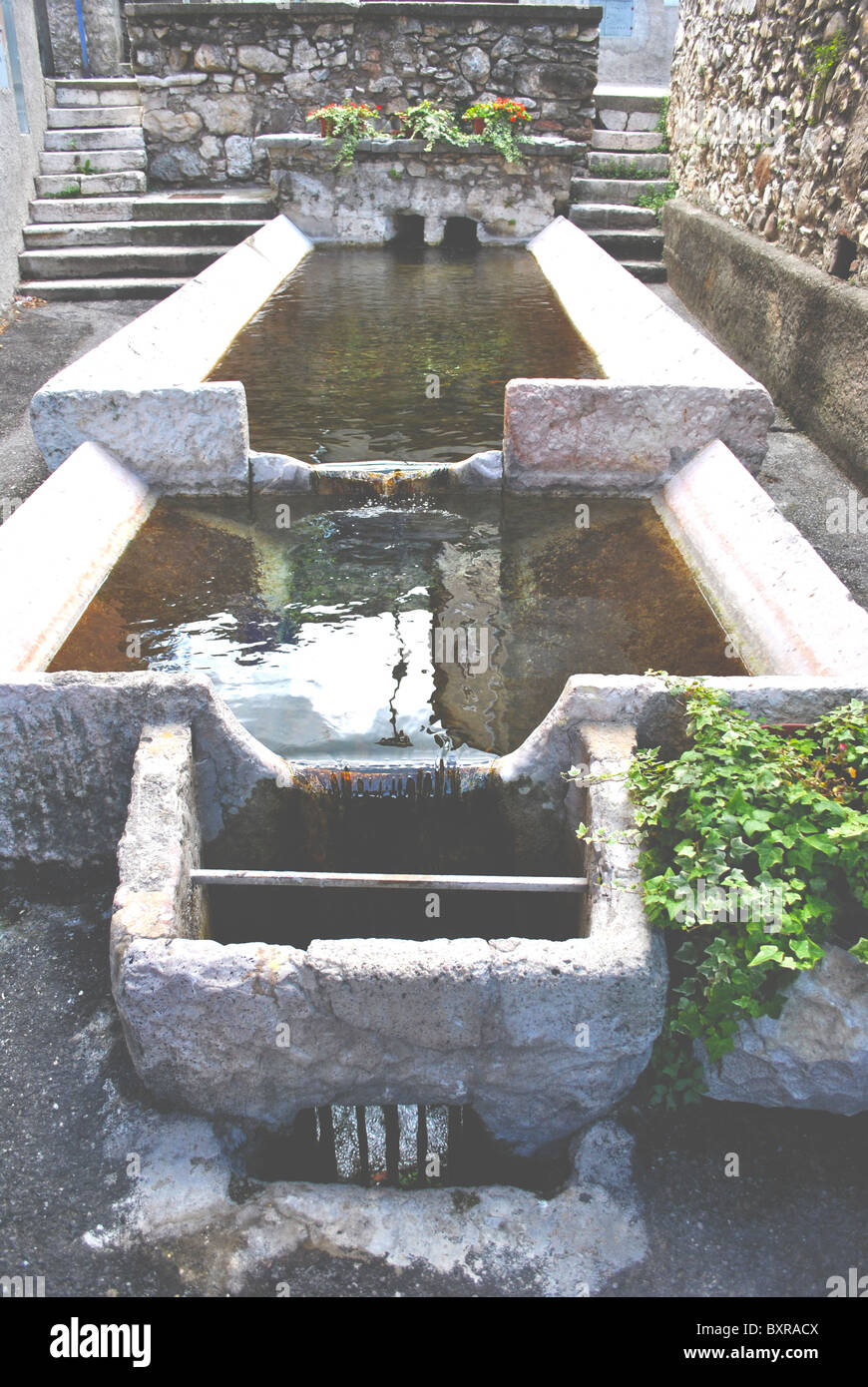 stone fountain with spring water Stock Photo - Alamy