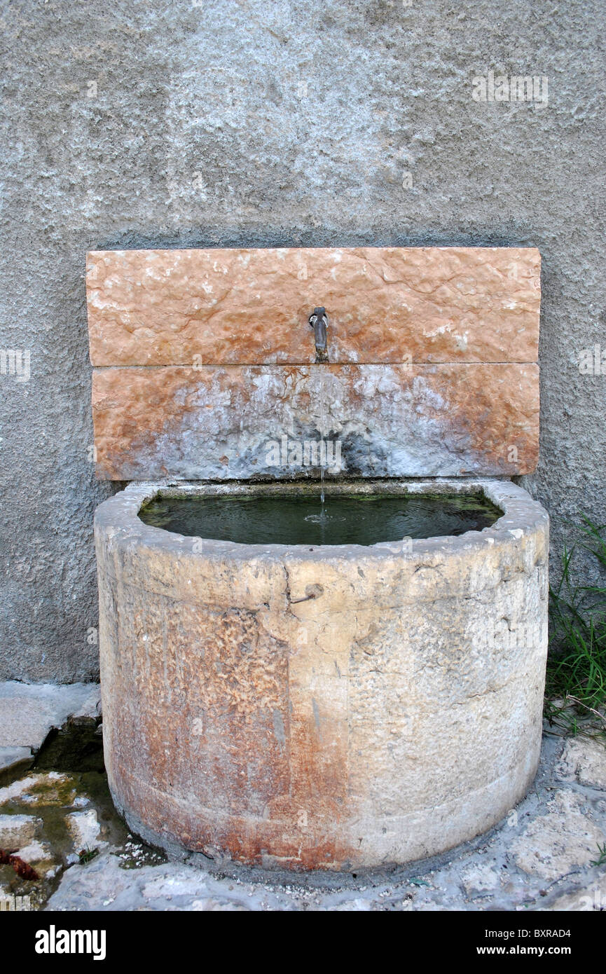 stone fountain with spring water Stock Photo - Alamy