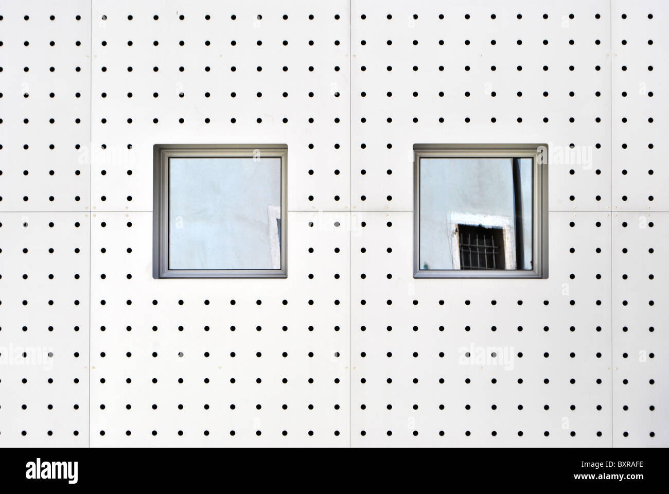 aluminum wall with holes and modern windows Stock Photo - Alamy