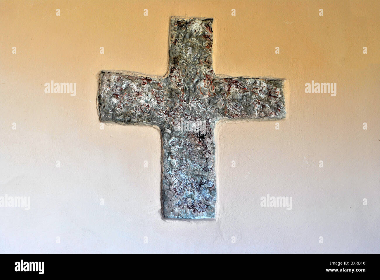 Catholic stone cross set in concrete wall Stock Photo - Alamy