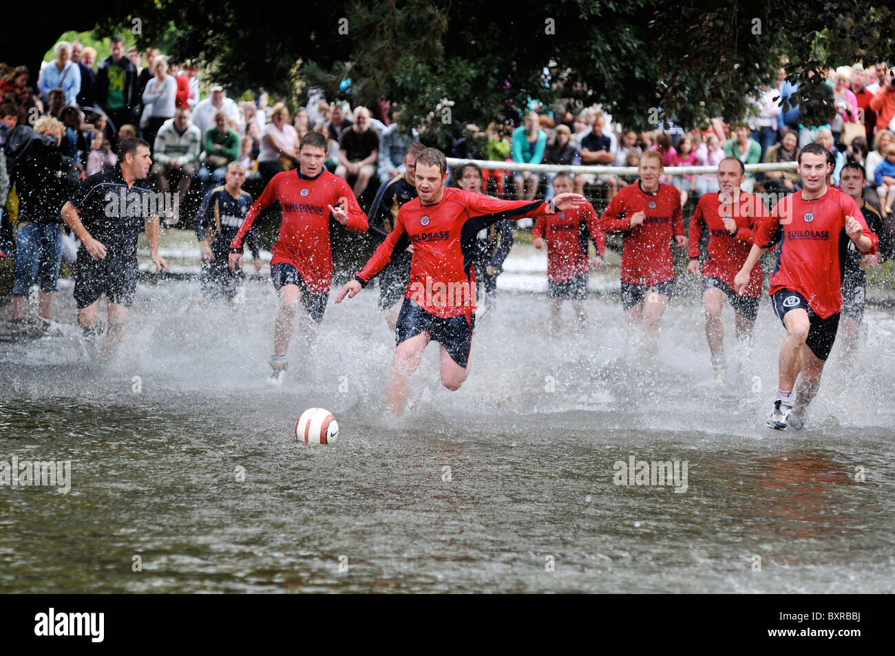 Football in the river Windrush, Bourton on the Water, Gloucestershire ...