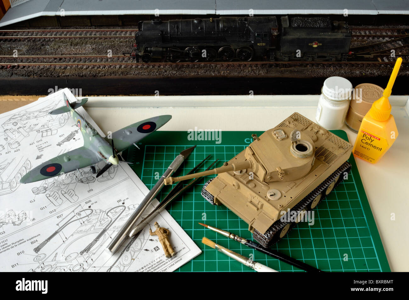 Modeler assembling plastic kit of German Tiger Tank and Supermarine ...