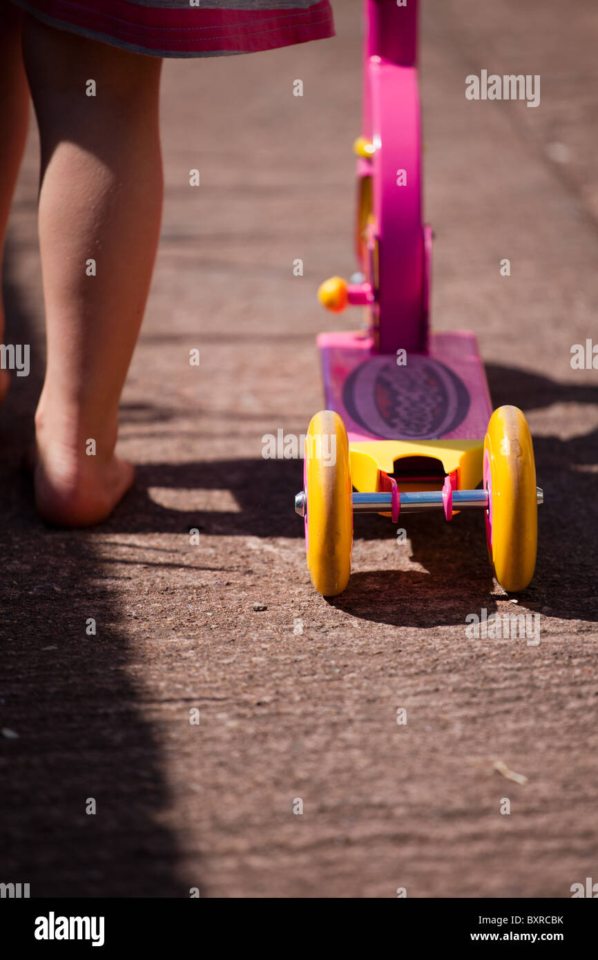 childs feet pushing a scooter Stock Photo - Alamy