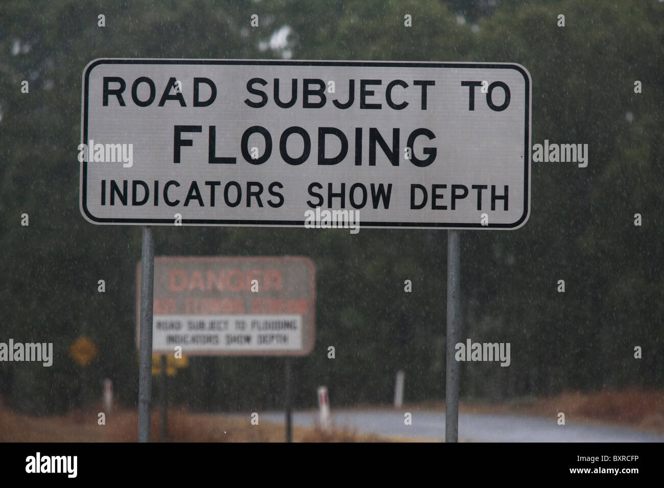 Australian flood warning road sign, during heavy rainfall. Queensland ...