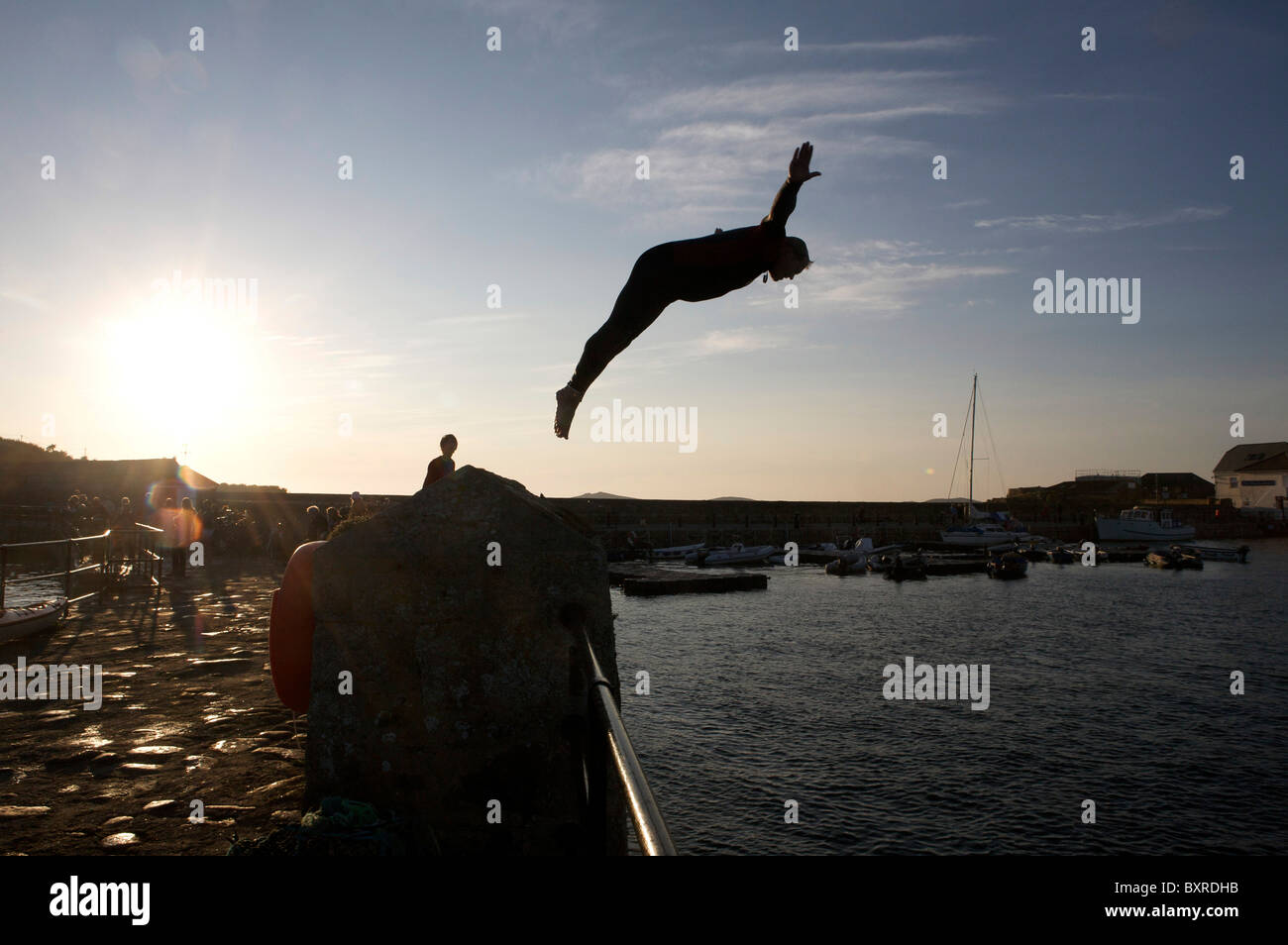 Pier jumping from the harbour wall st Mary's Isles of Scilly, uk Stock ...