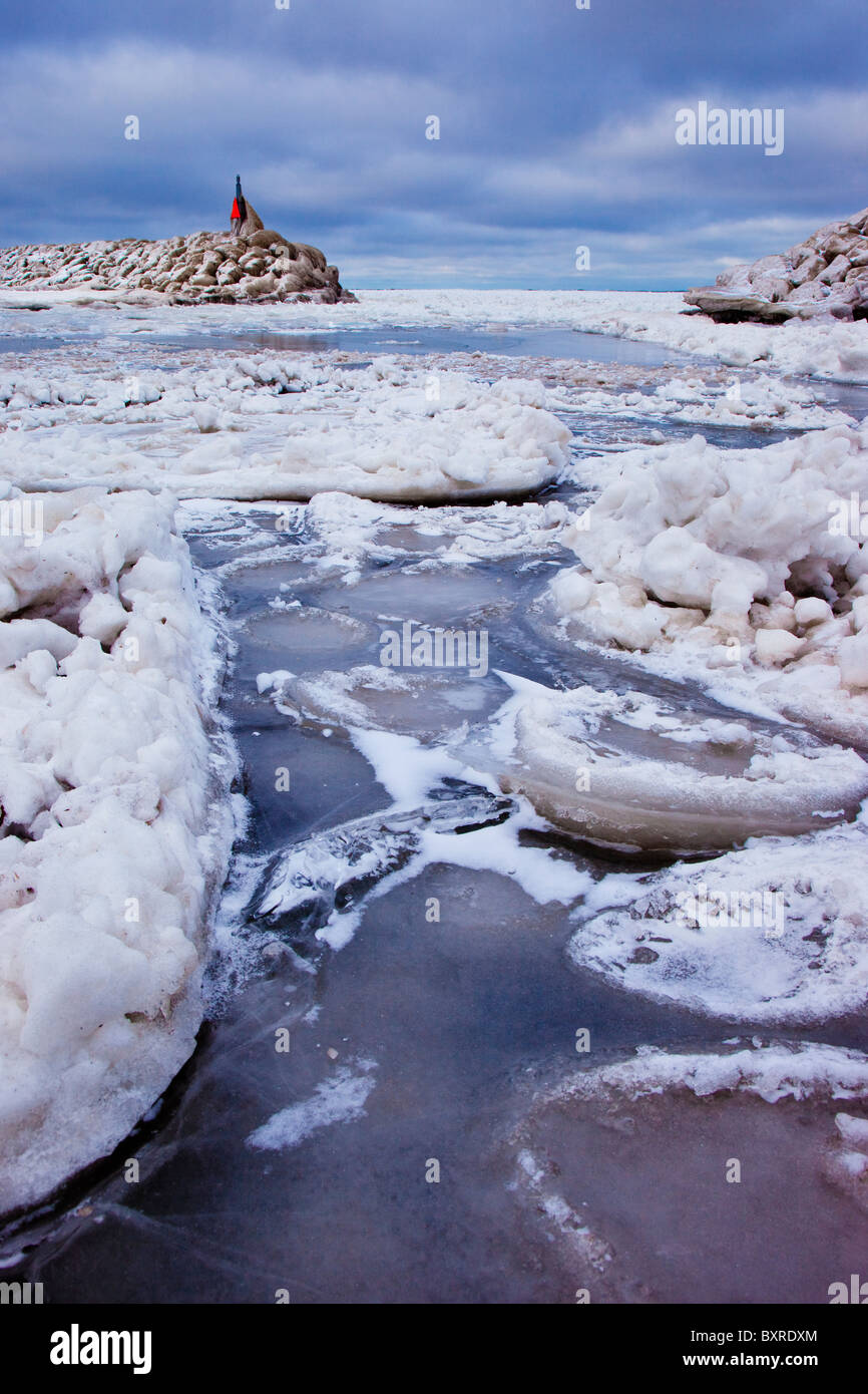 Ice flow surrounding a stone breakwater near the shore of Lake Erie in ...