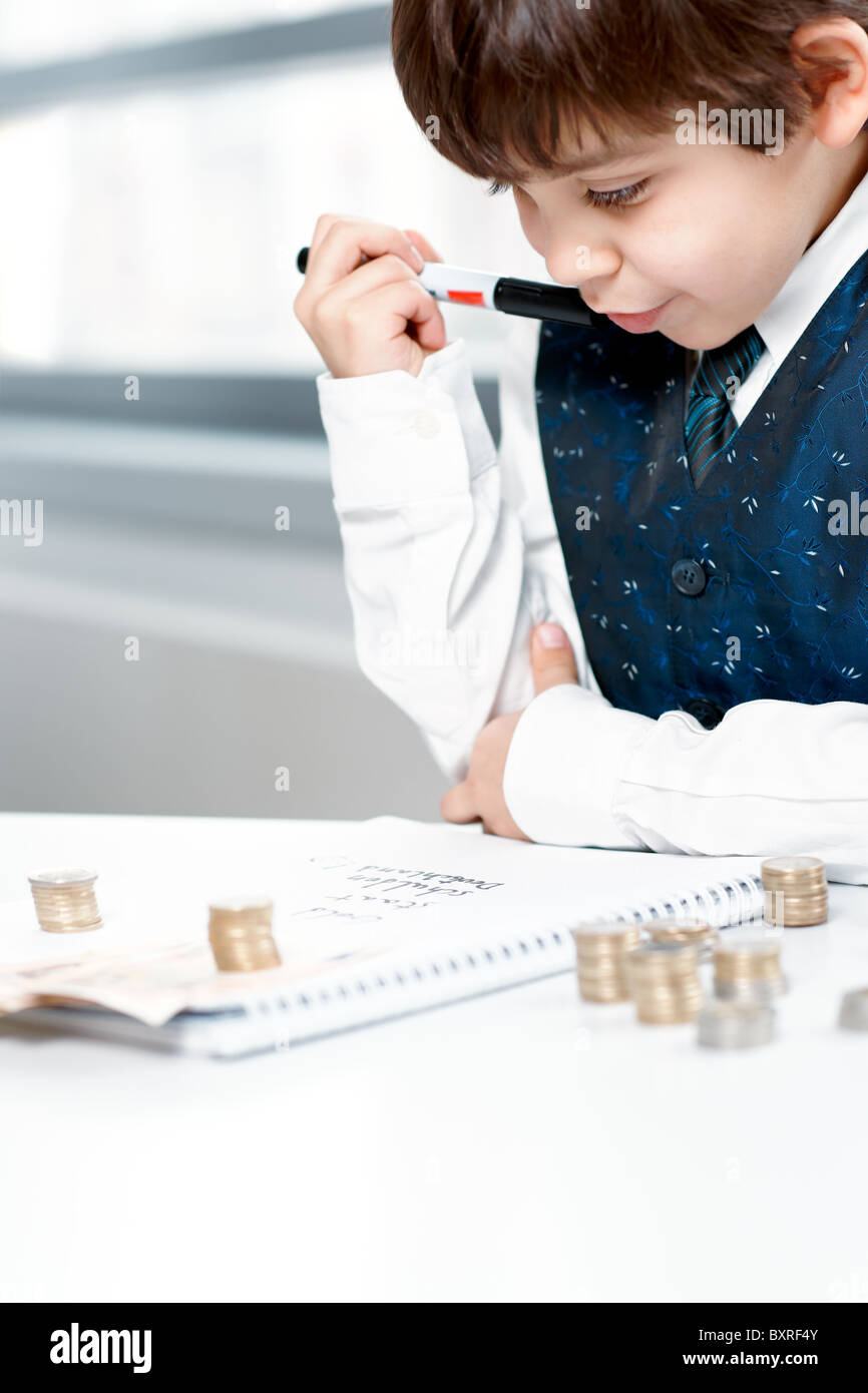 Child counting money and taking notes Stock Photo - Alamy