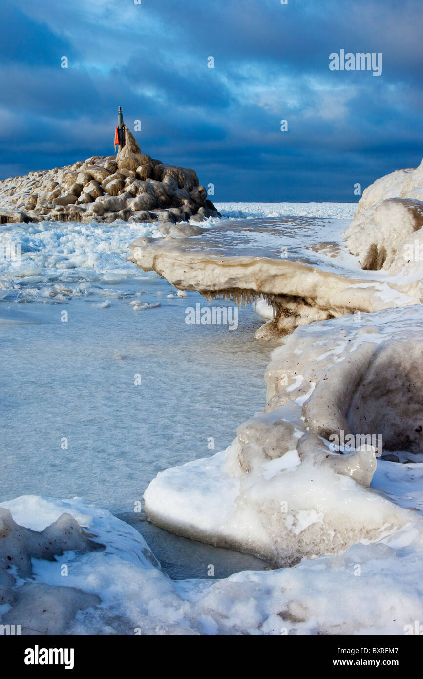 Ice flow surrounding a stone breakwater near the shore of Lake Erie in ...