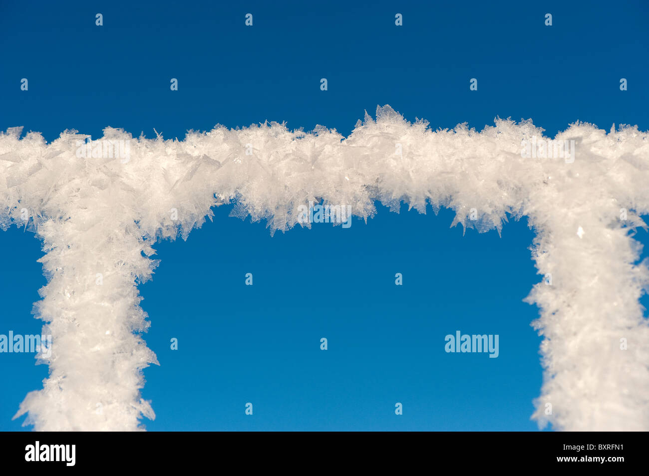 Close up of Hoar frost forming on wire fence, forming ice crystals ...