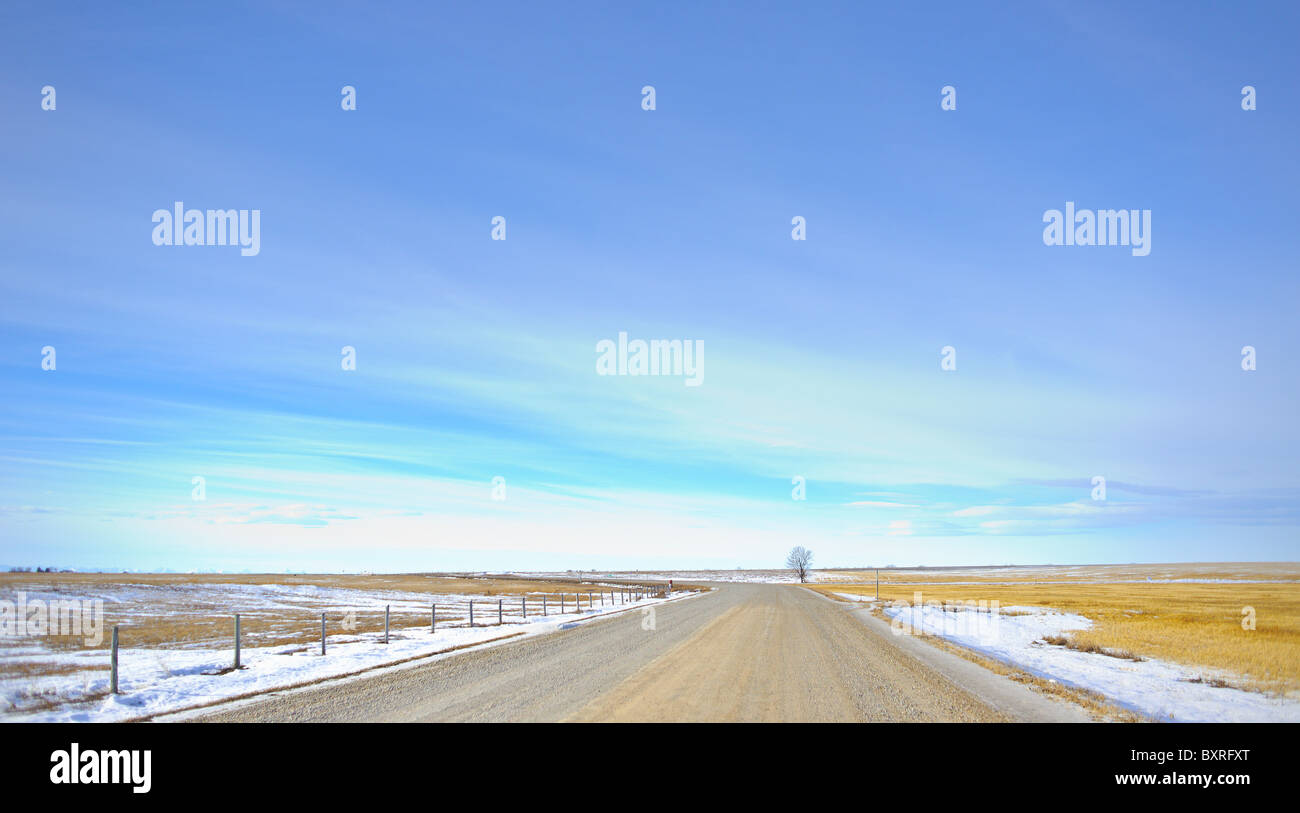 Gravel road in winter with blue sky somewhere south of Lethbridge ...