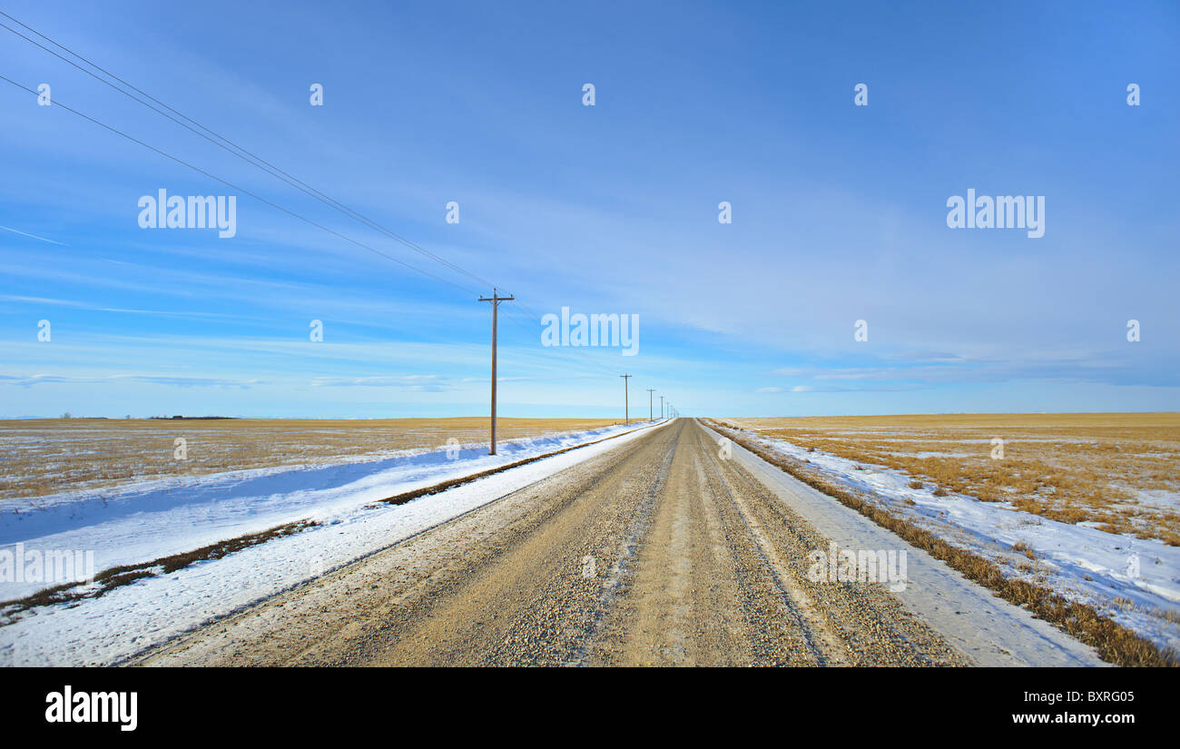 Gravel road in winter with blue sky somewhere south of Lethbridge ...
