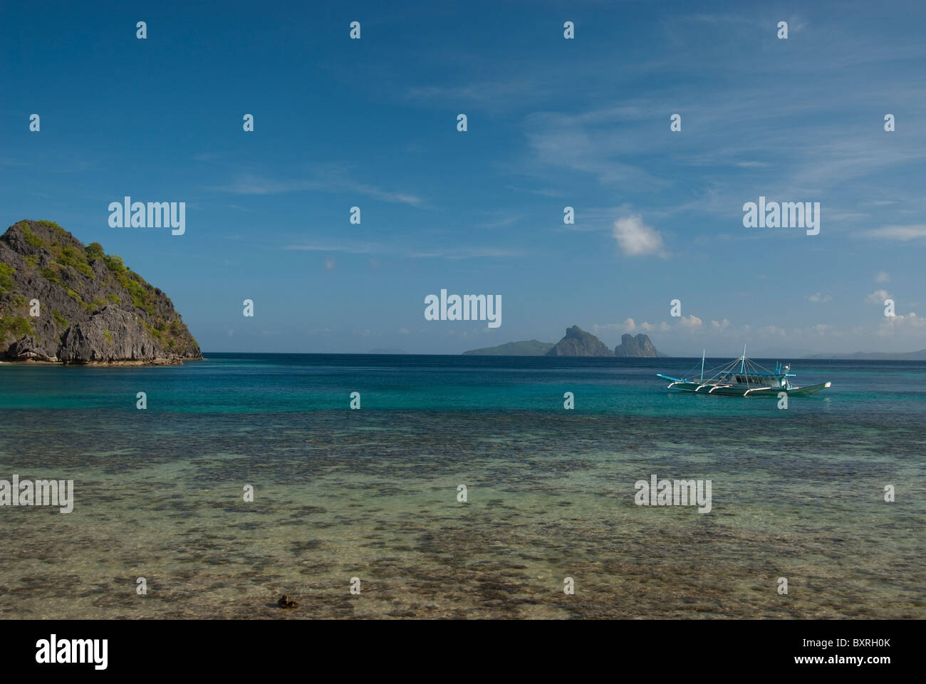 Shallow reef, boat in background, Tubbataha, Palawan, The Philippines ...