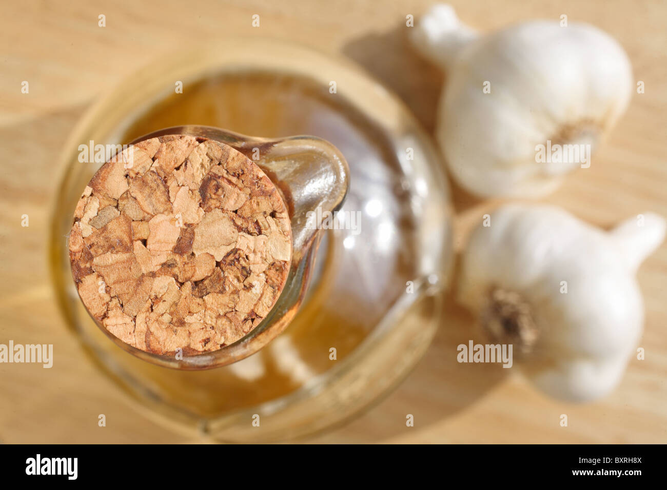 close-up of cooking oil jar with cork and garlic from above Stock Photo ...
