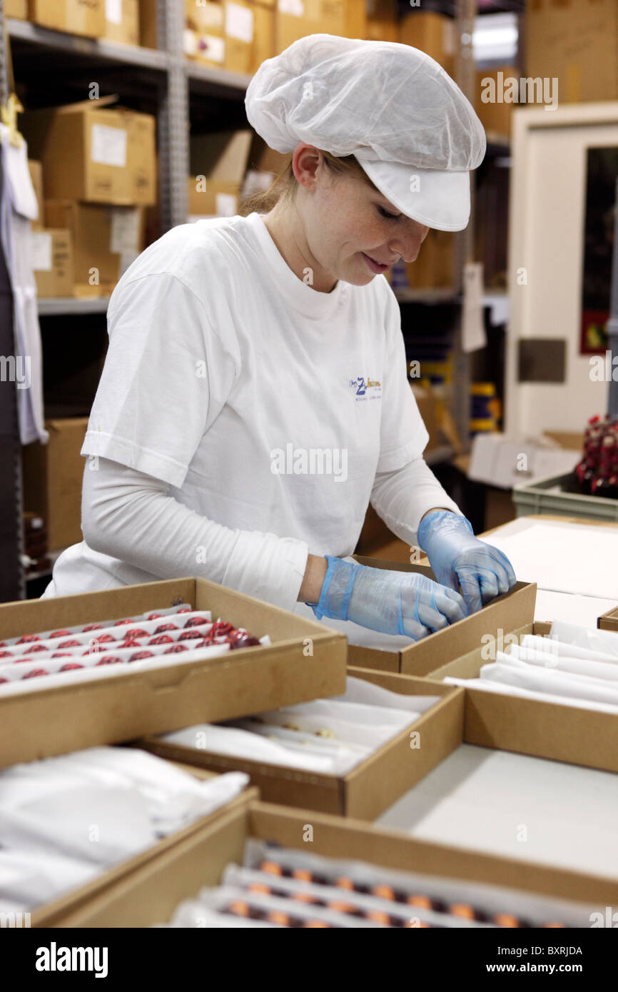 A member of staff packages different chocolates at the Zenhäusern ...