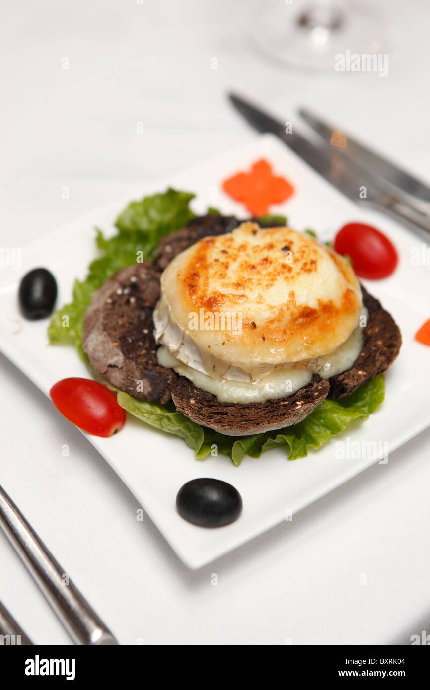 Gratinated goat's cheese with olive oil & honey served on toast served ...