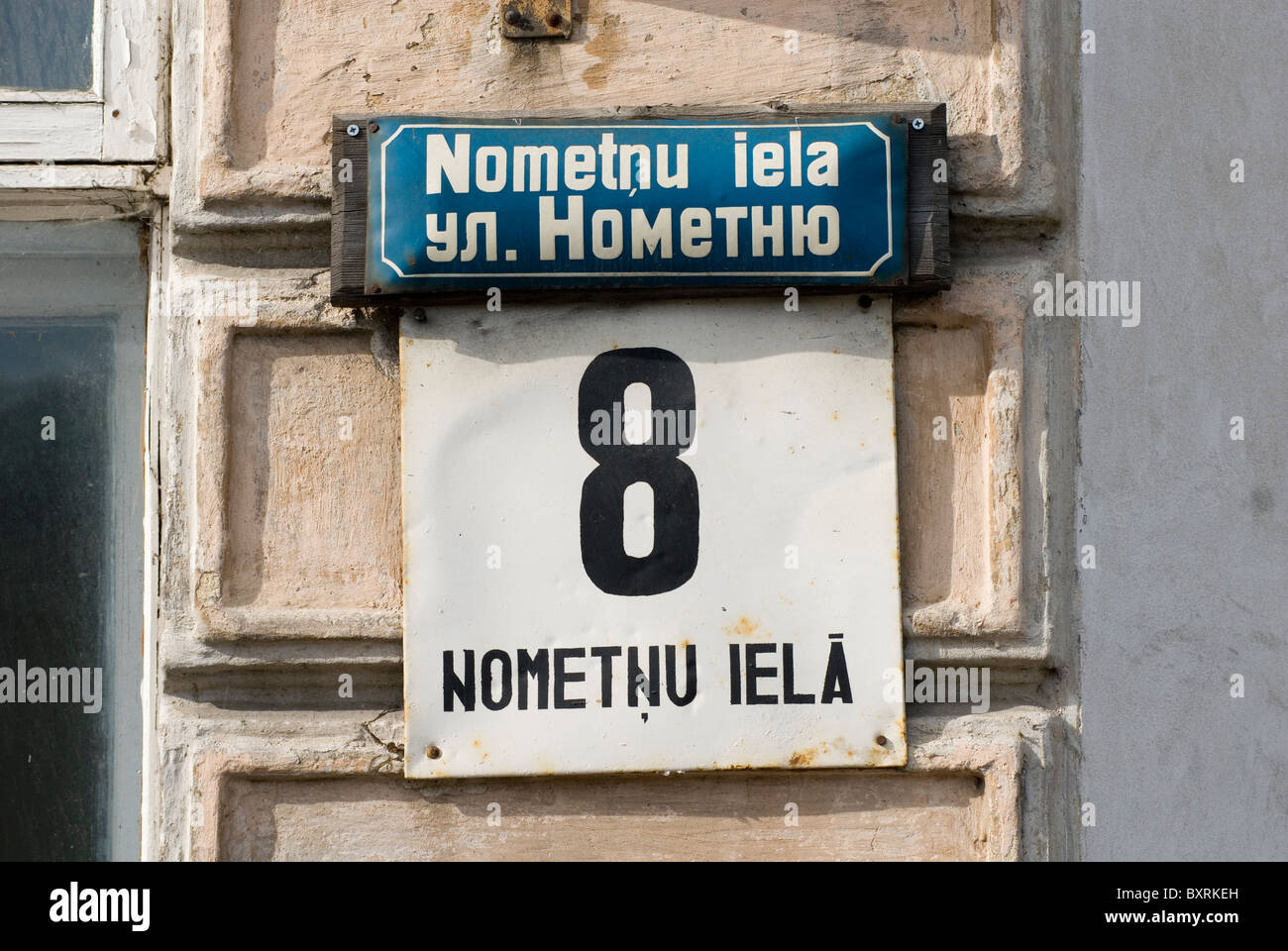 Bilingual latvian and russian sign on house hi-res stock photography ...