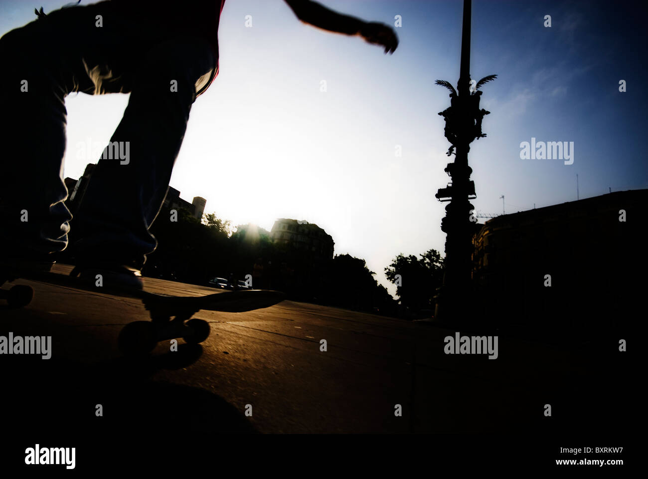 horizontal shoot of skateboarder riding through barcelona just for ...
