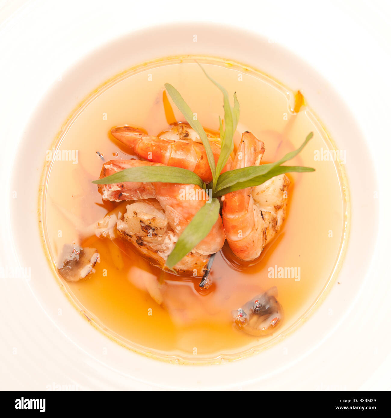 Dish of grilled tiger prawns and beef broth in a vegetables wok, shot ...