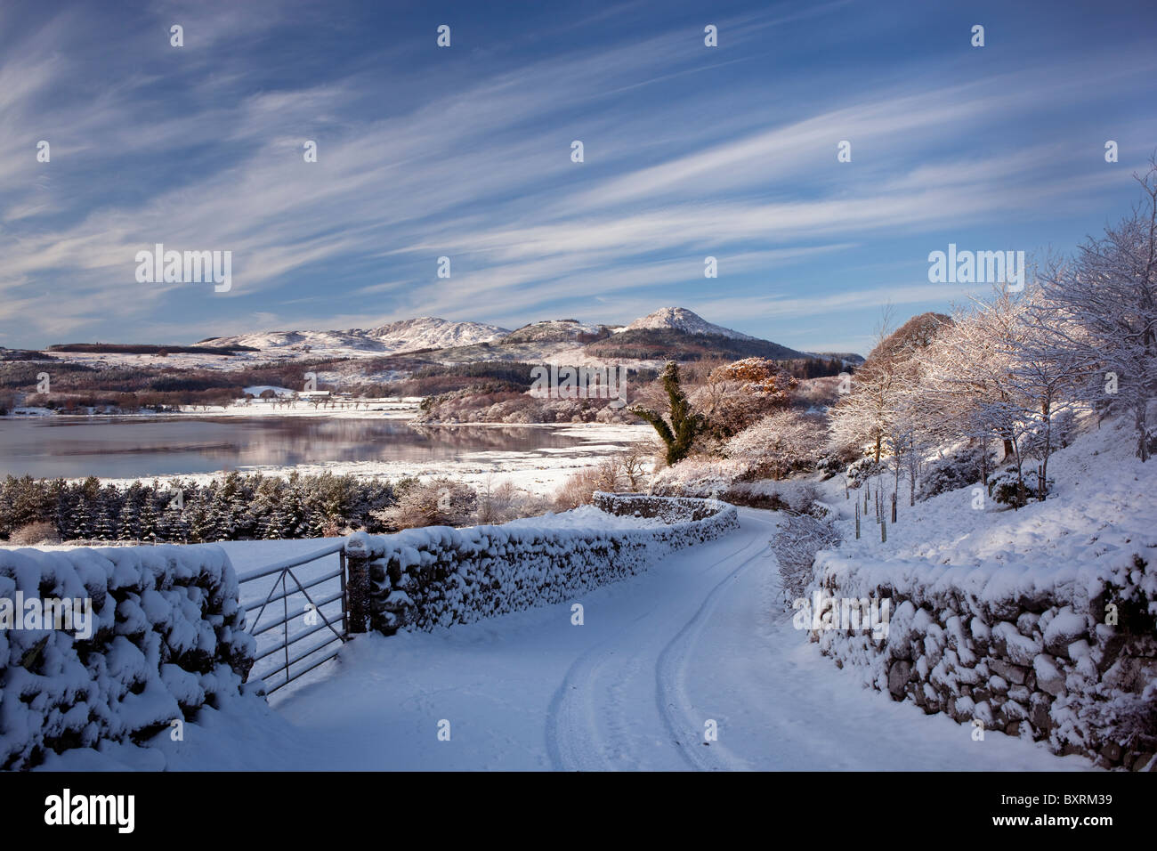 Scenic winter landscape snow covered road winding past Almorness House ...