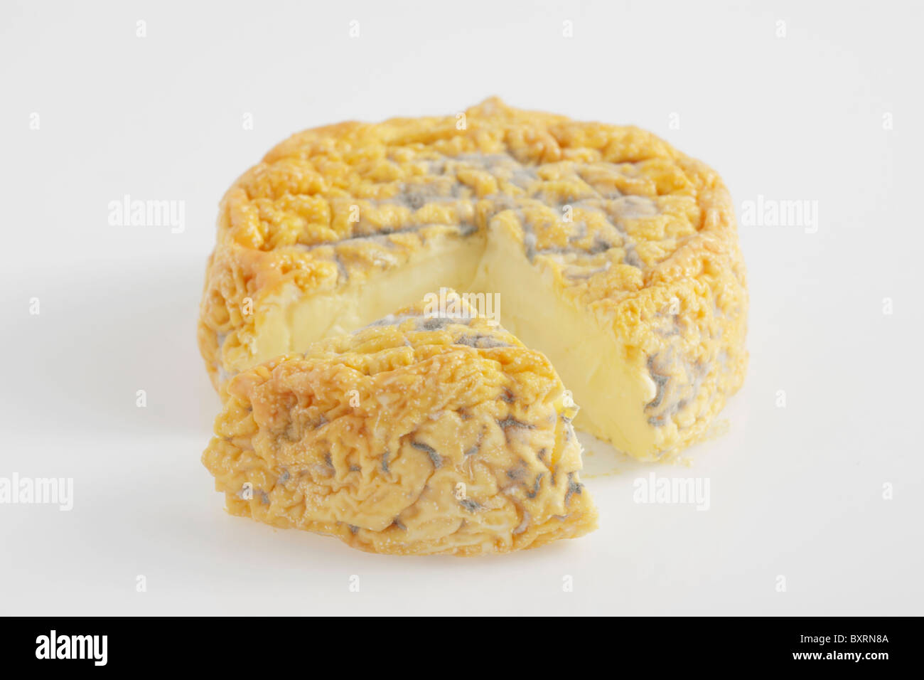 Whole round and slice of French Plaisir au Chablis cow's milk cheese ...