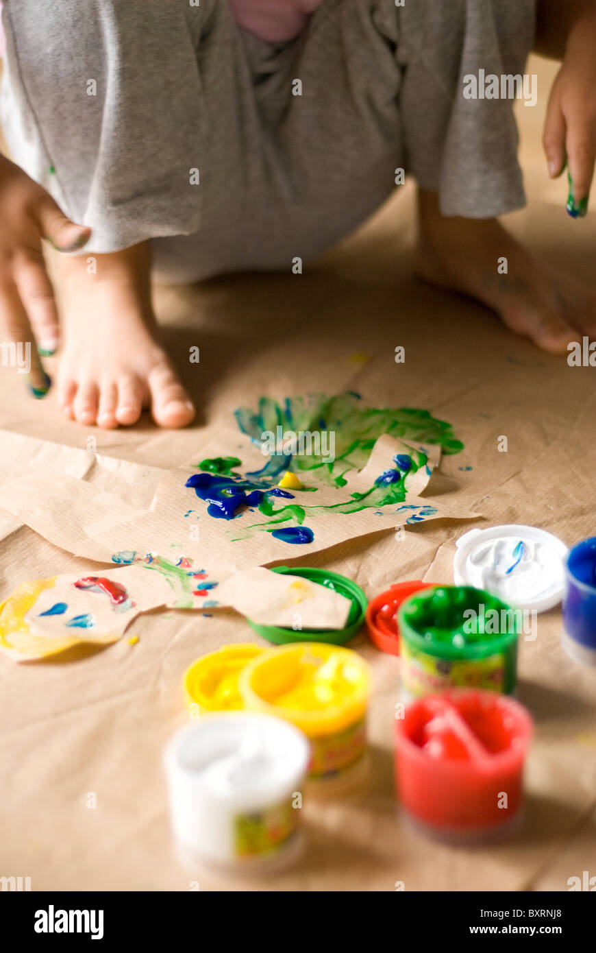 Child having fun and painting with foot feet Stock Photo - Alamy