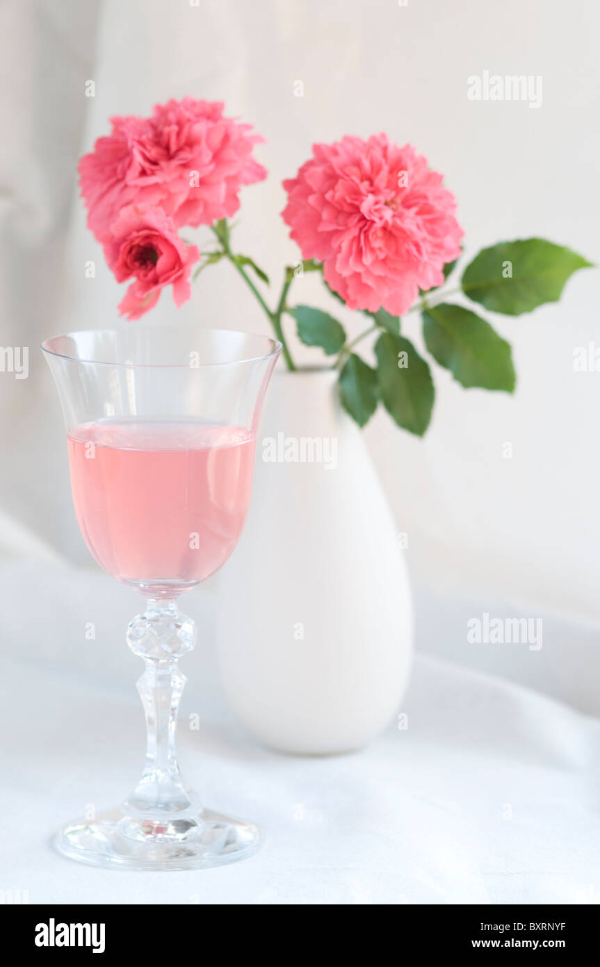 Liqueur with rose aroma and rosy roses Stock Photo - Alamy