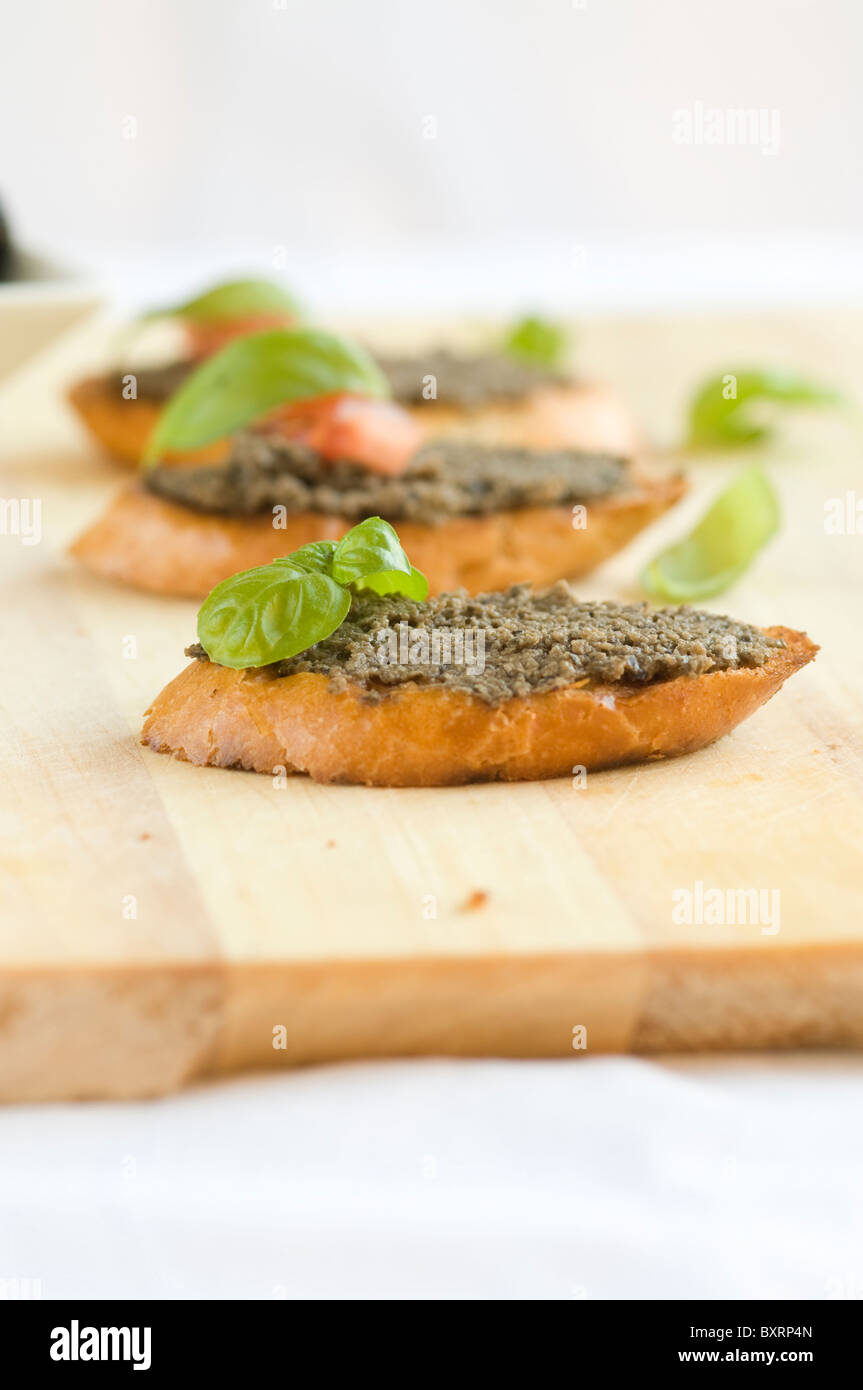 Traditional fresh tapenade - olive paste on bread Stock Photo - Alamy