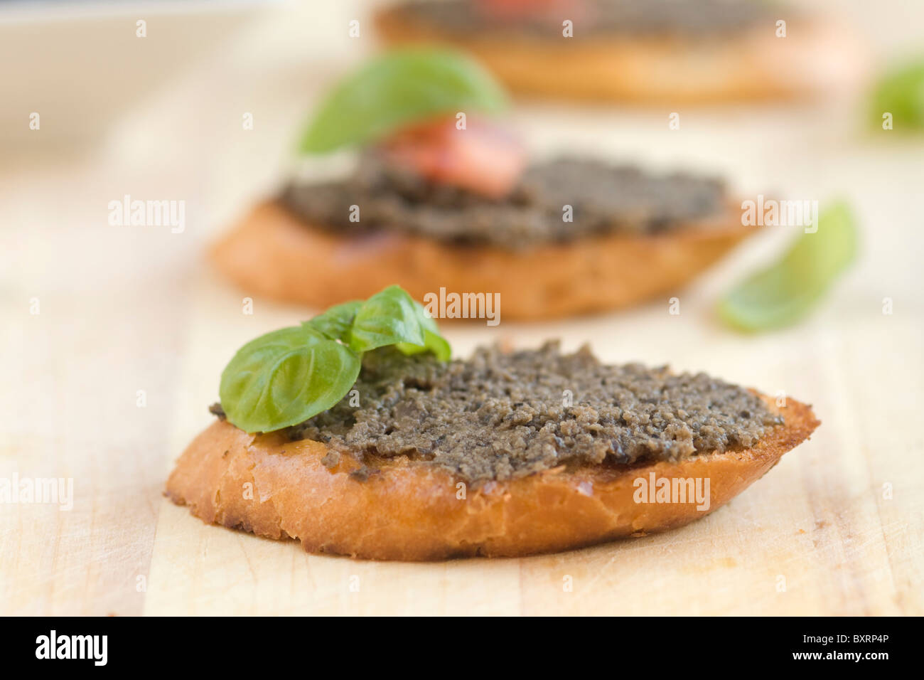 Traditional fresh tapenade - olive paste on bread Stock Photo - Alamy