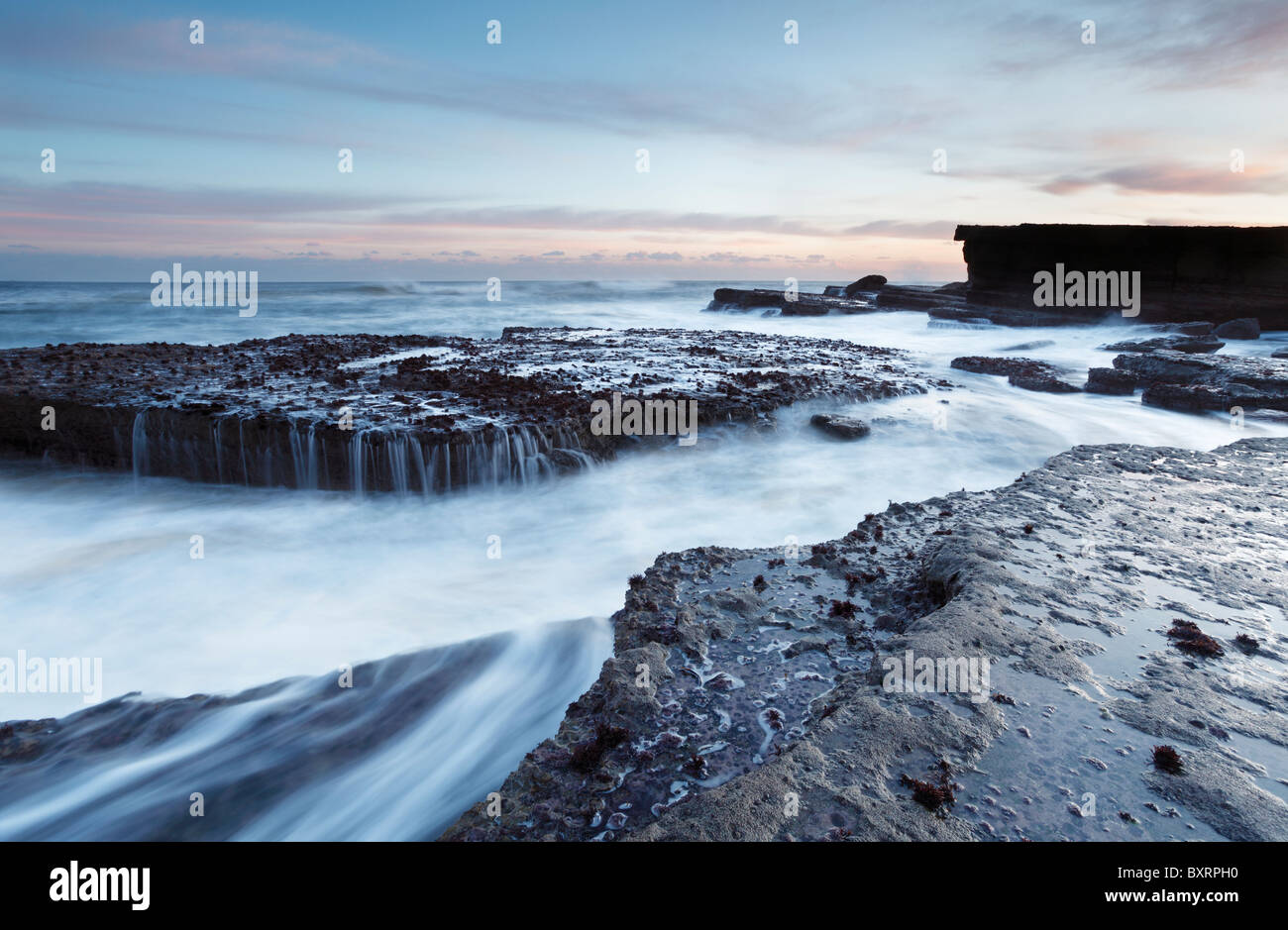 Waves crash around a rocks at Filey Brigg, North Yorkshire Stock Photo ...