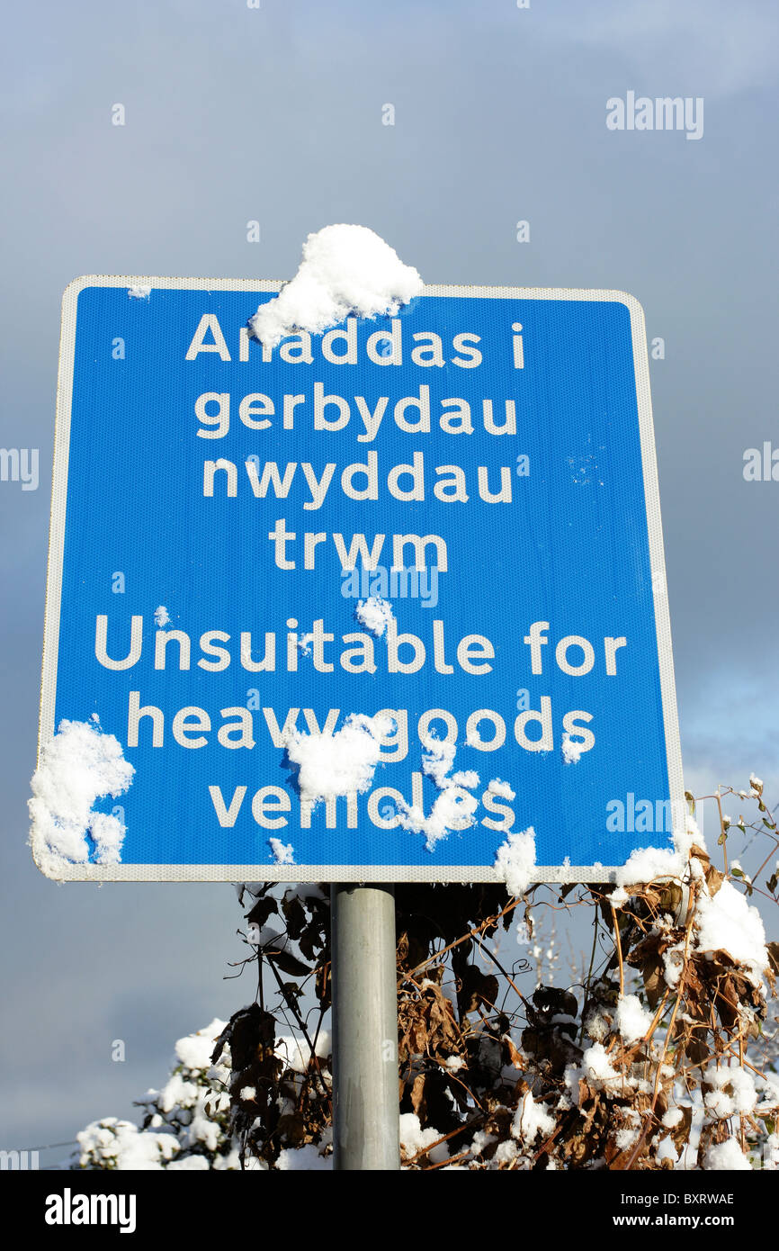 A snow covered traffic sign warning of an unsuitable road for heavy ...