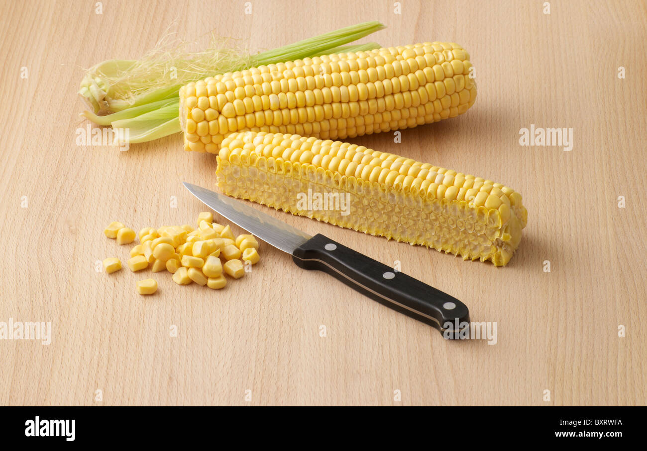 Corn cob with knife, close-up Stock Photo - Alamy