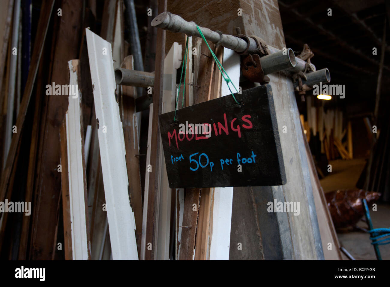 A pile of used and spare wood moldings for sale at 50p per foot in a ...