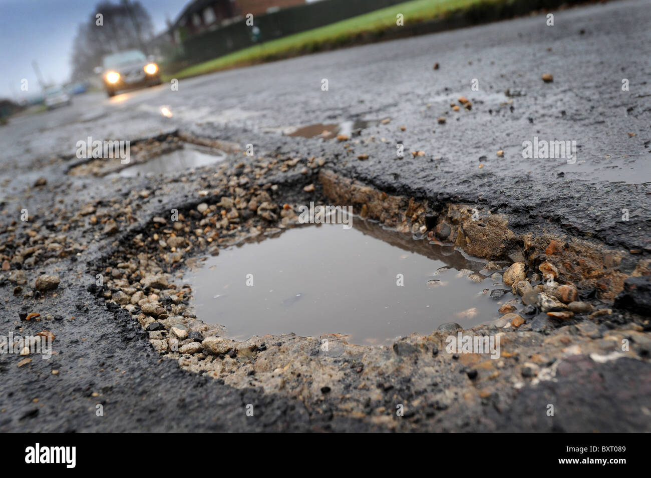 Pot holes in the roads as snow and ice damage the road surface Stock ...
