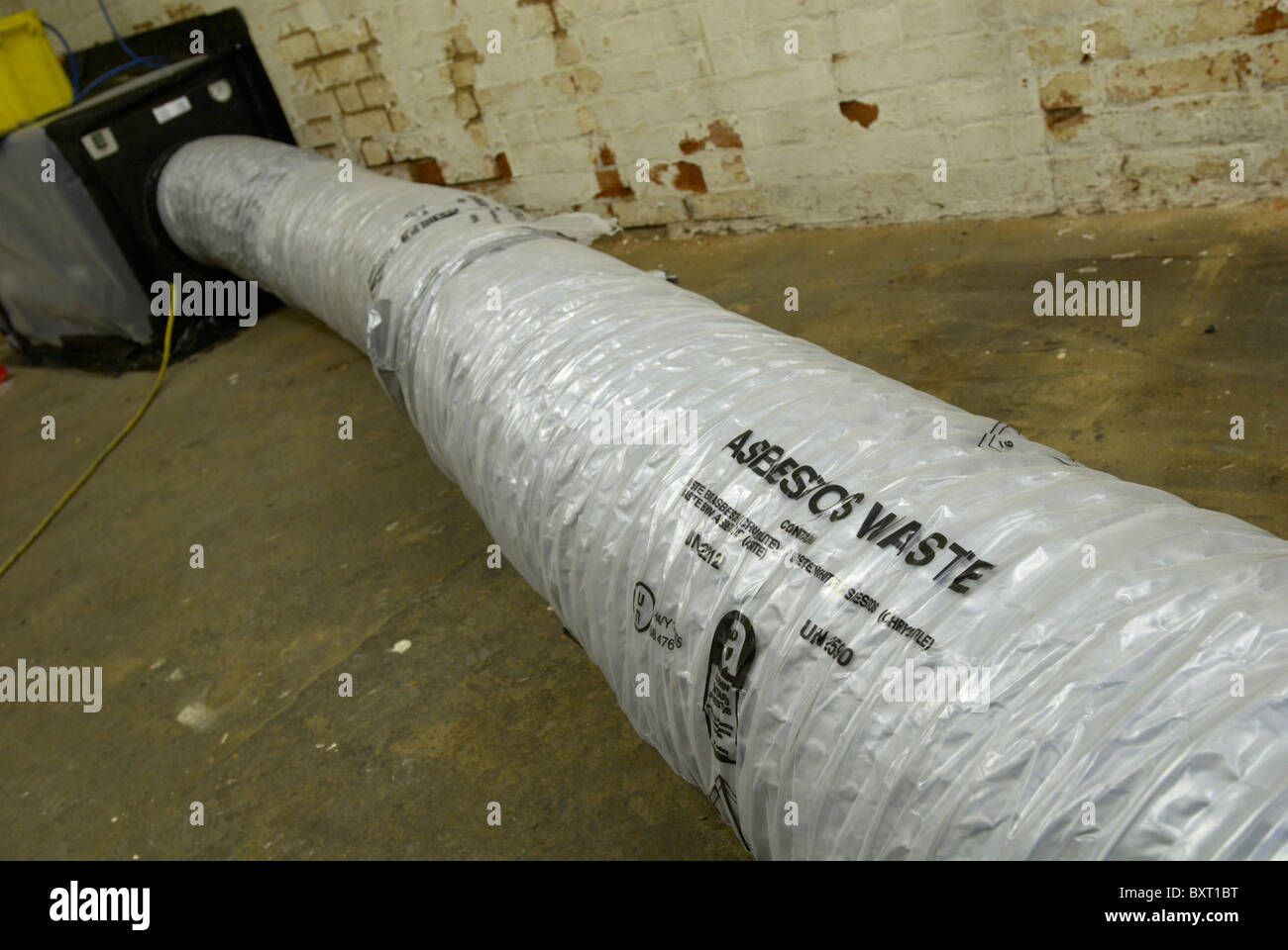 Asbestos removal waste tube Stock Photo - Alamy